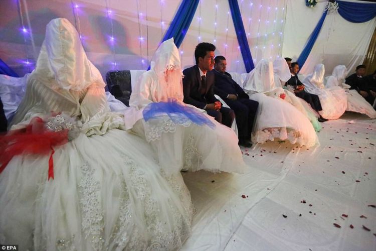 Mass wedding ceremony sees 34 couples tie the knot as they share their ...